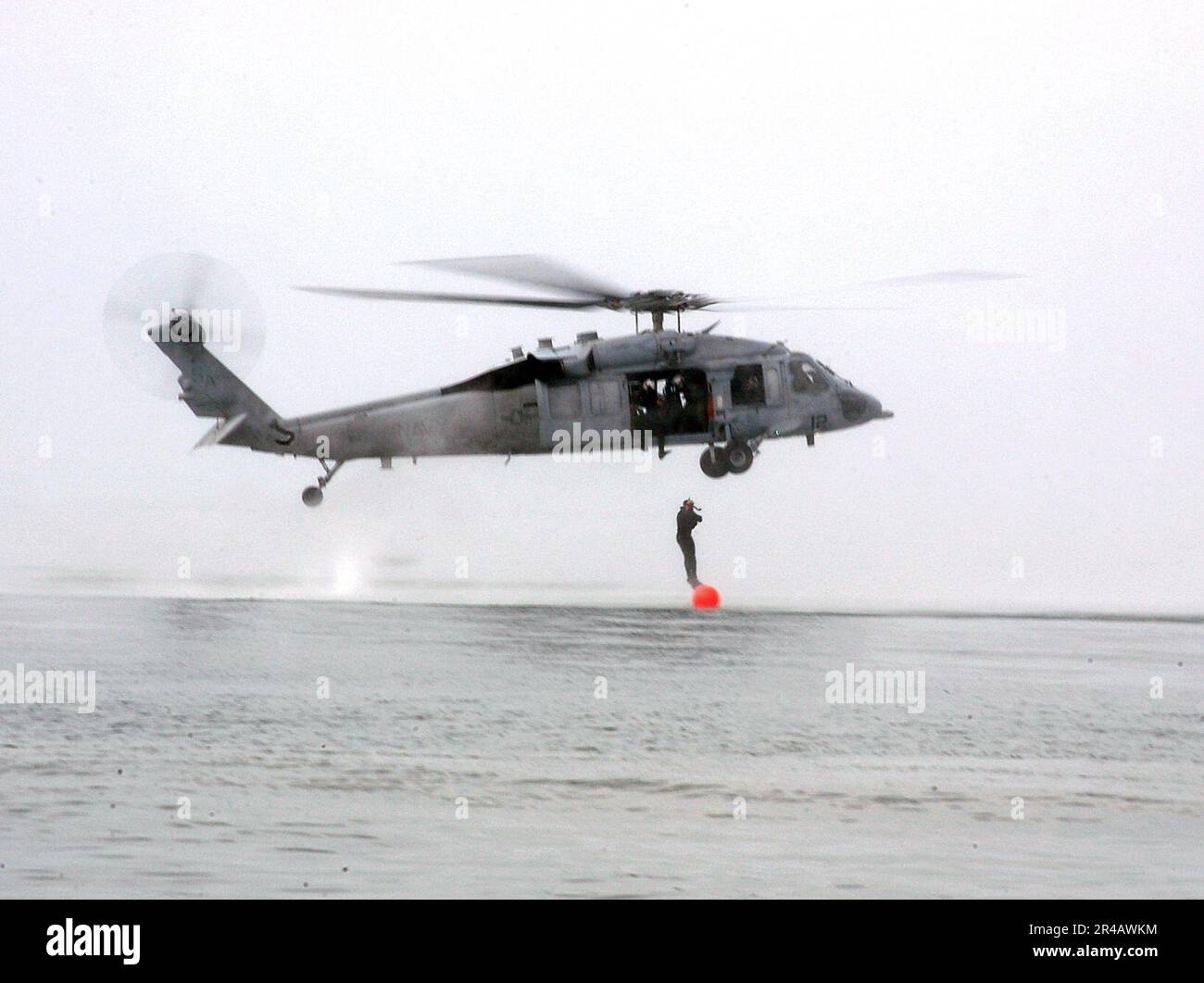 US Navy A search and rescue swimmer jumps out of a MH-60S Seahawk ...
