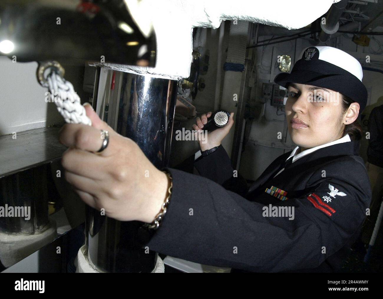 US Navy Quartermaster 2nd Class chimes the ship's bell on the ...