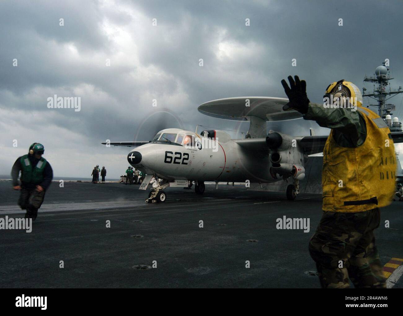 US Navy Aviation Boatswain Mate 3rd Class signals to the Flight Deck ...