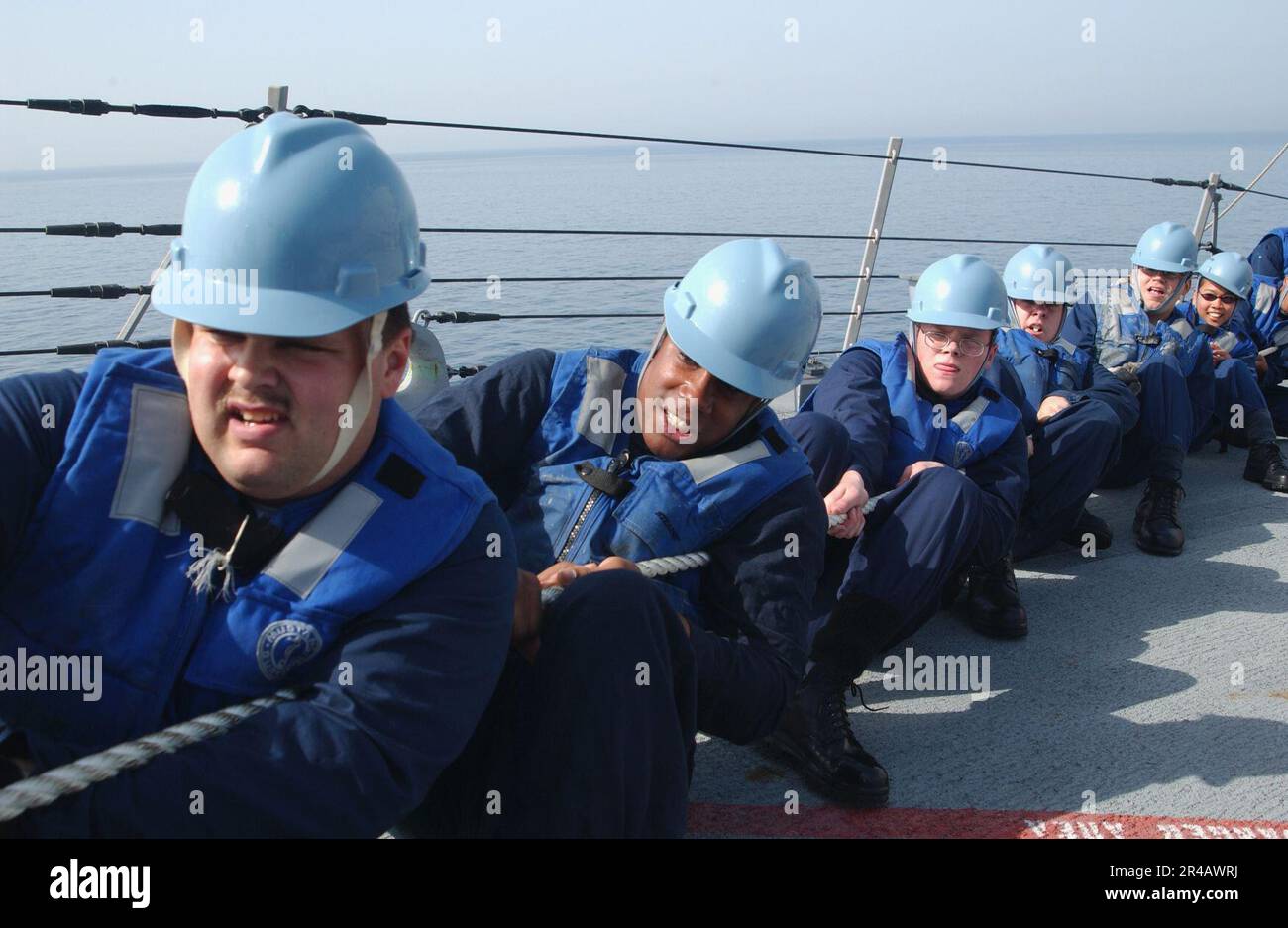 US Navy Line handlers aboard the Arleigh Burke-class guided missile ...