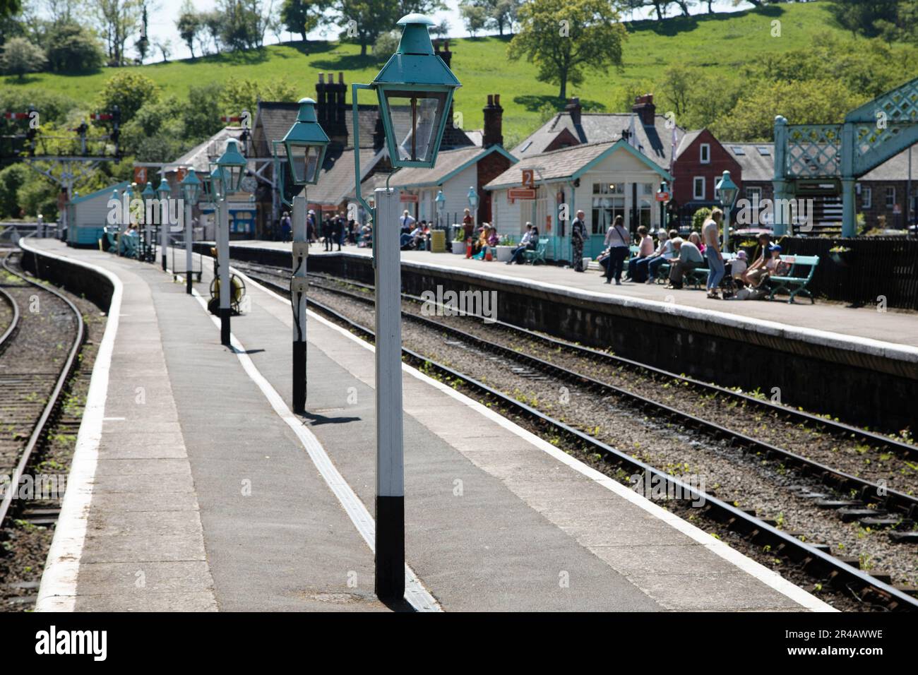 A busy train station with passengers walking along the platform Stock ...