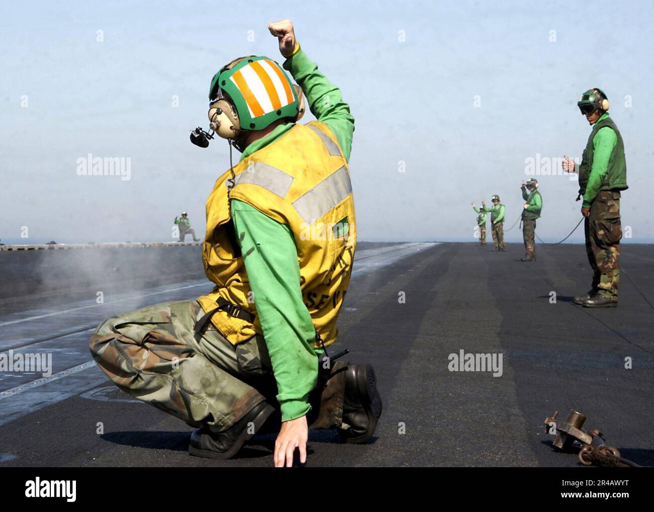US Navy Catapult Safety Observer Aviation Boatswains Mate signals to ...