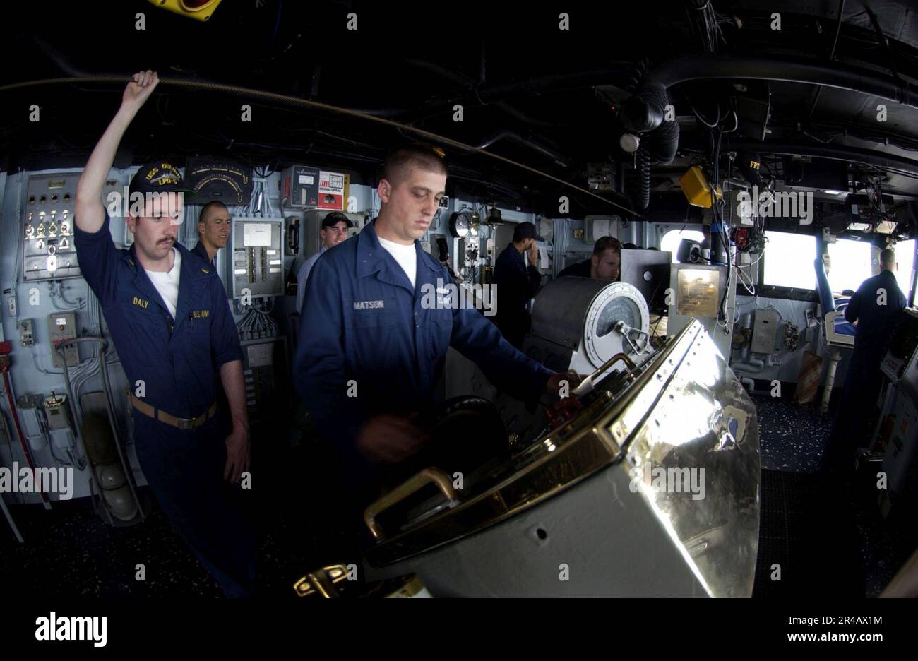 US Navy Helm Safety Officer Ens. left, monitors Master Helmsman Boatswain's Mate Seaman during ...