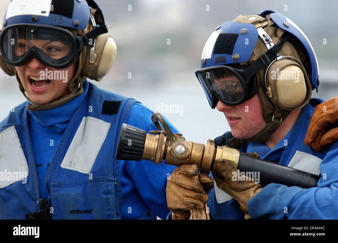 US Navy Hose Team Leader, Airman left, shouts a verbal command to ...