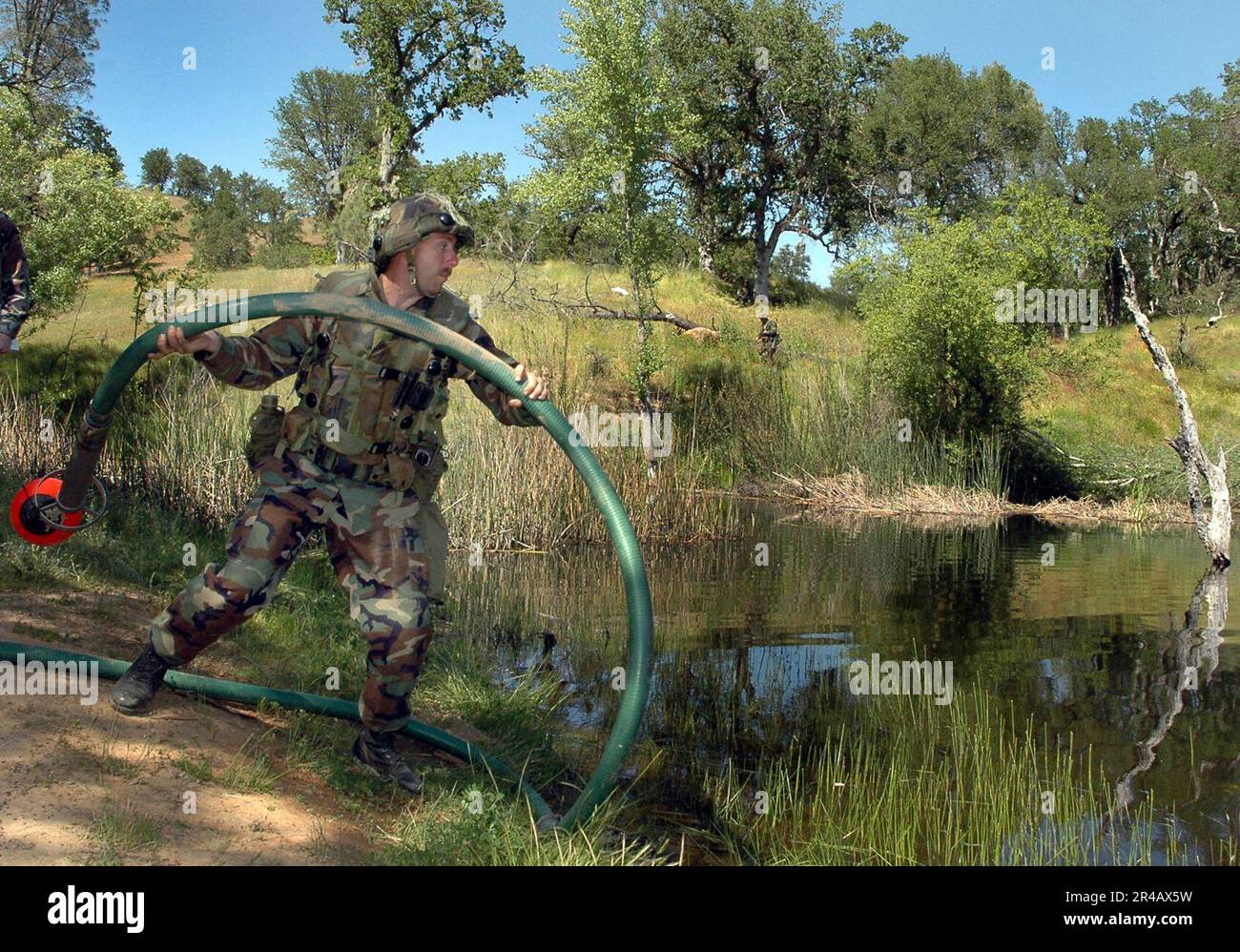 US Navy Utilitiesman 2nd Class assigned to Naval Mobile Construction ...