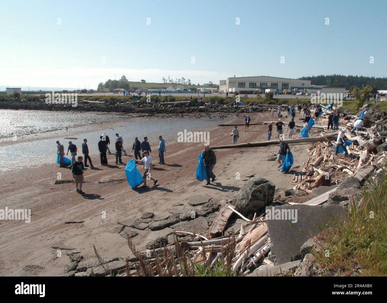 US Navy Sailors participate during a base cleanup of the beach on the ...