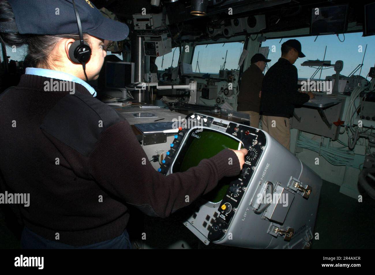 US Navy Operations Specialist 3rd Class mans an AN-SPA-25G Radar ...