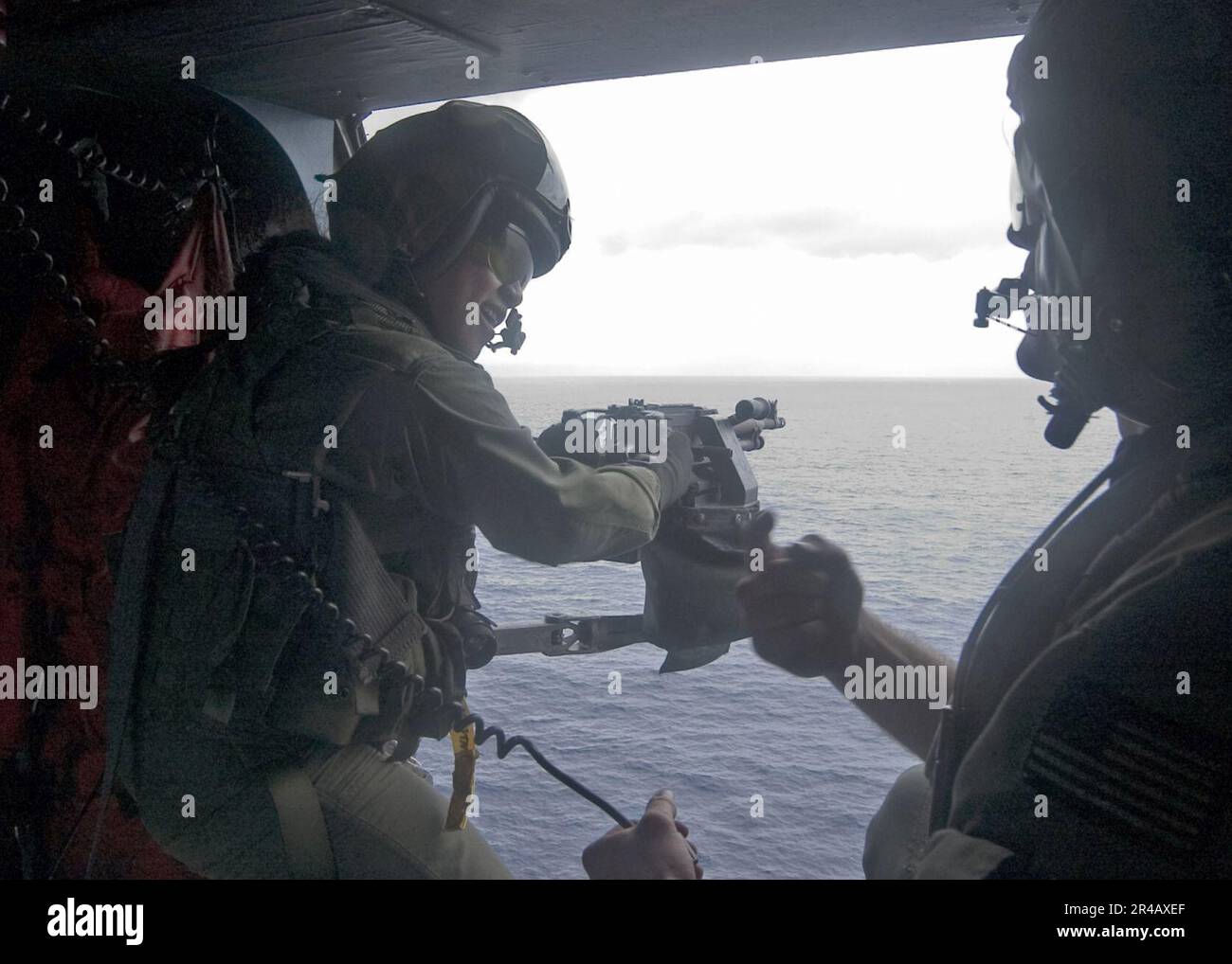 US Navy Aviation Warfare Systems Operator 3rd Class smiles after firing ...