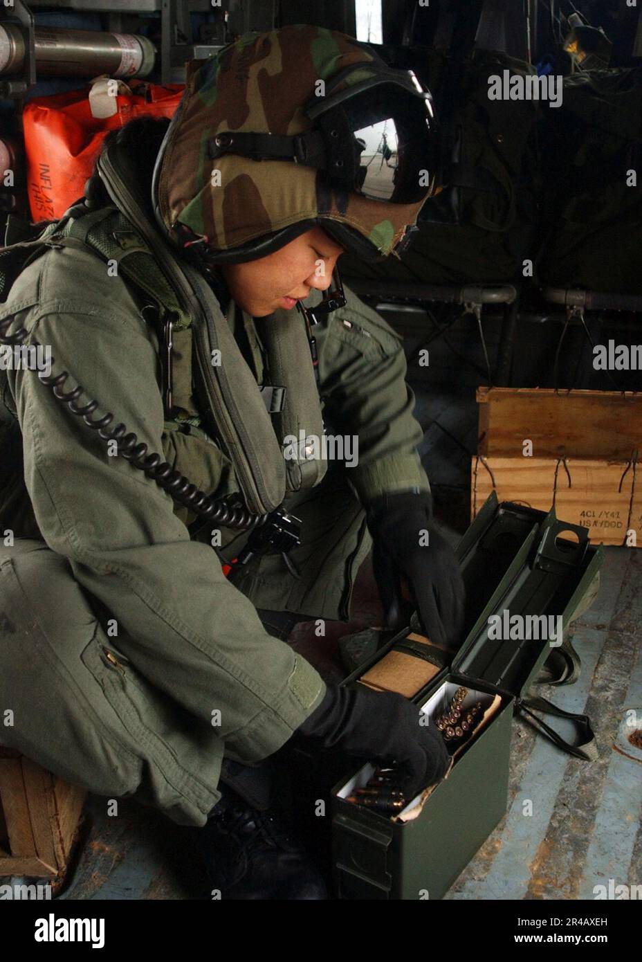 US Navy Aviation Warfare Systems Operator 3rd Class readies ammunition ...