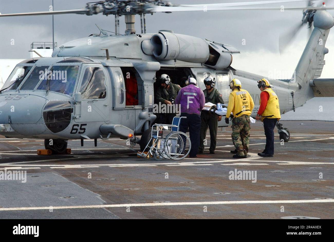 US Navy Personnel place a discharged Indonesian patient into an MH-60S ...