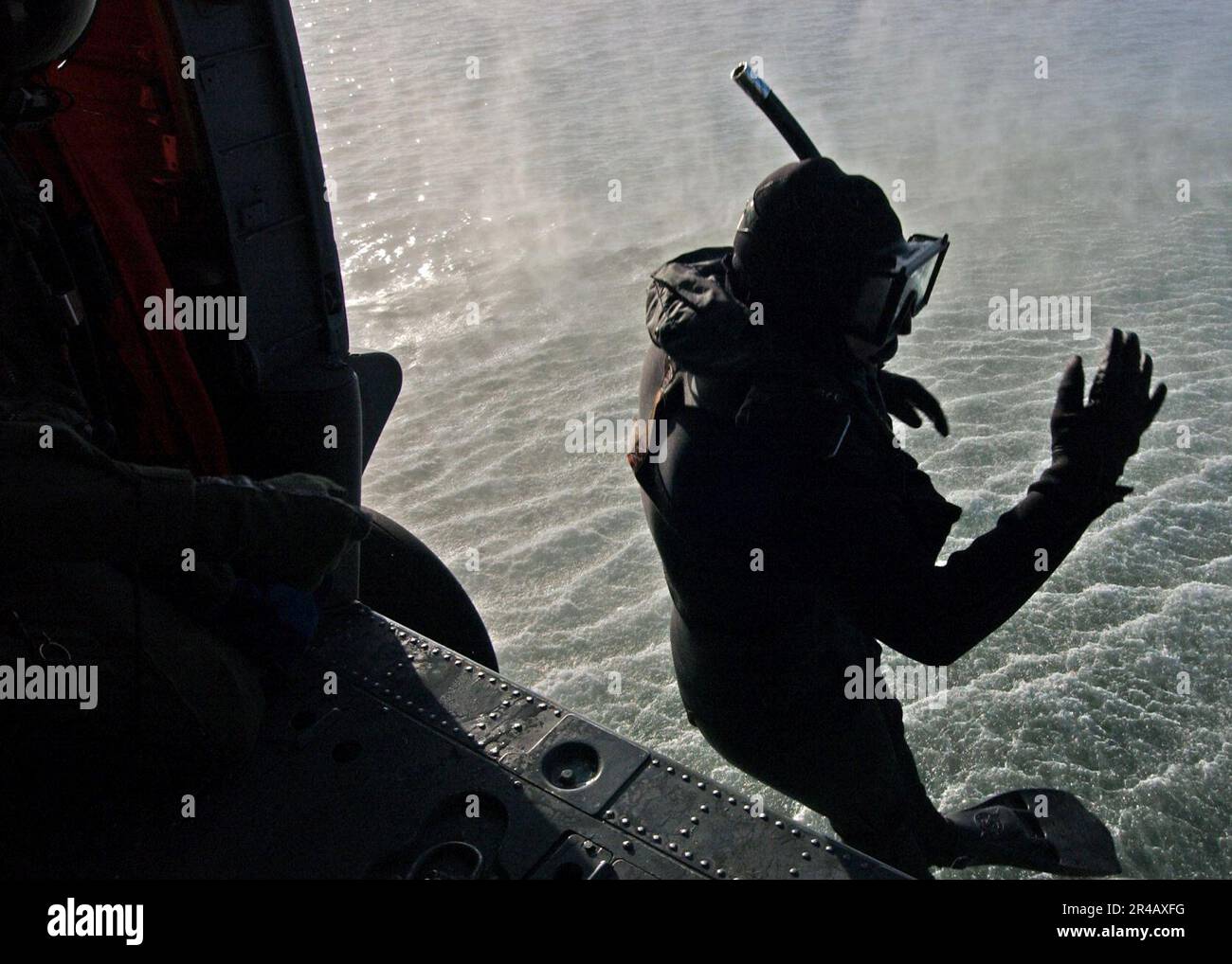 US Navy Aviation Electronics Technician 3rd Class jumps from a MH-60S ...