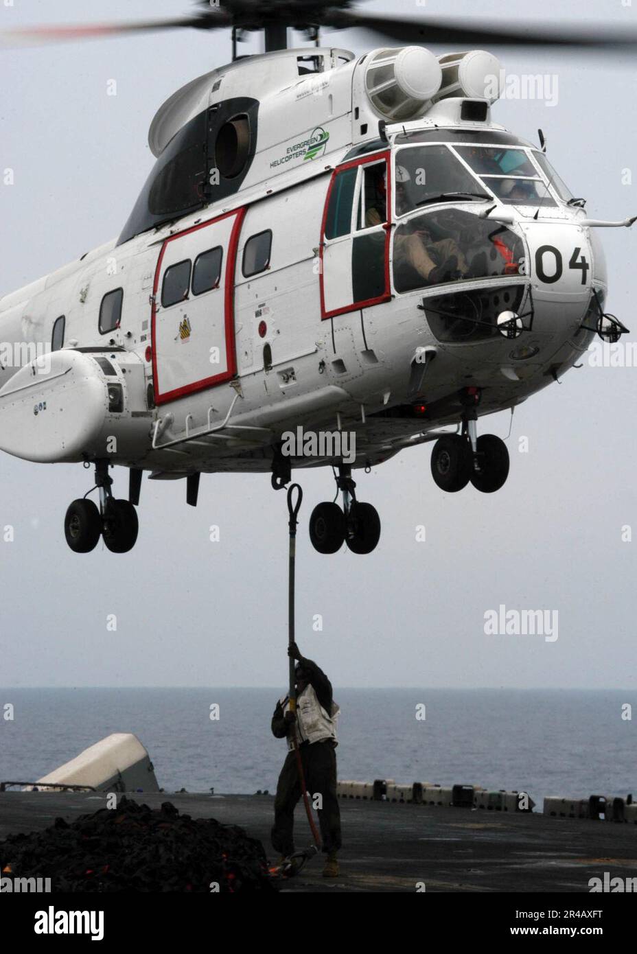 US Navy Gunnery Sgt. connects a cargo pendant to a SA 330 Puma ...