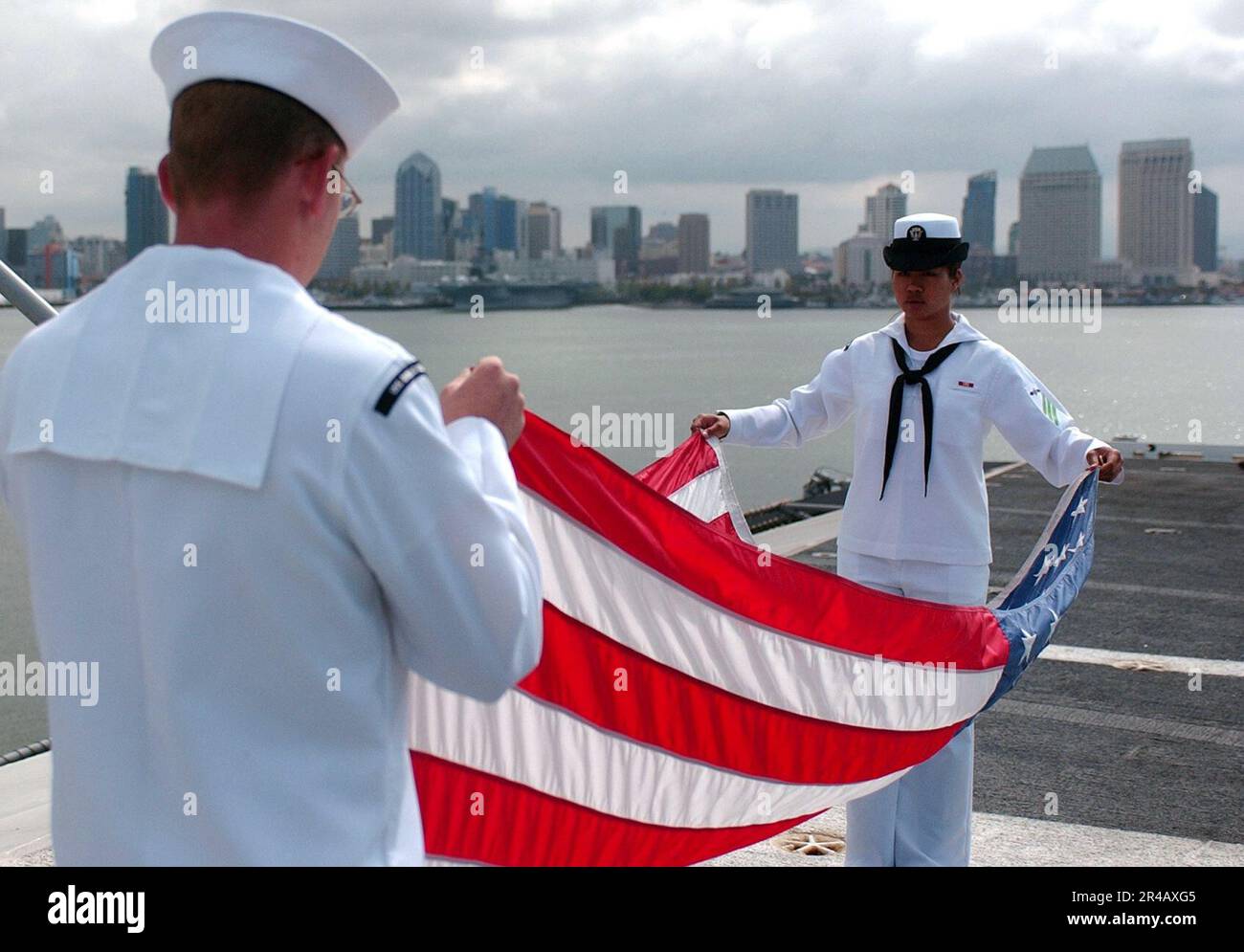 US Navy Fire Controlman 3rd Class left, is assisted by Aviation ...