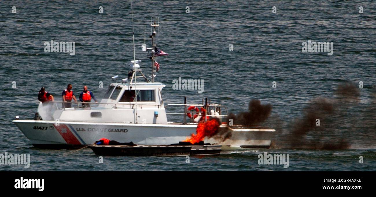 US Navy A U.S. Coast Guard patrol boat battles a simulated vessel fire ...