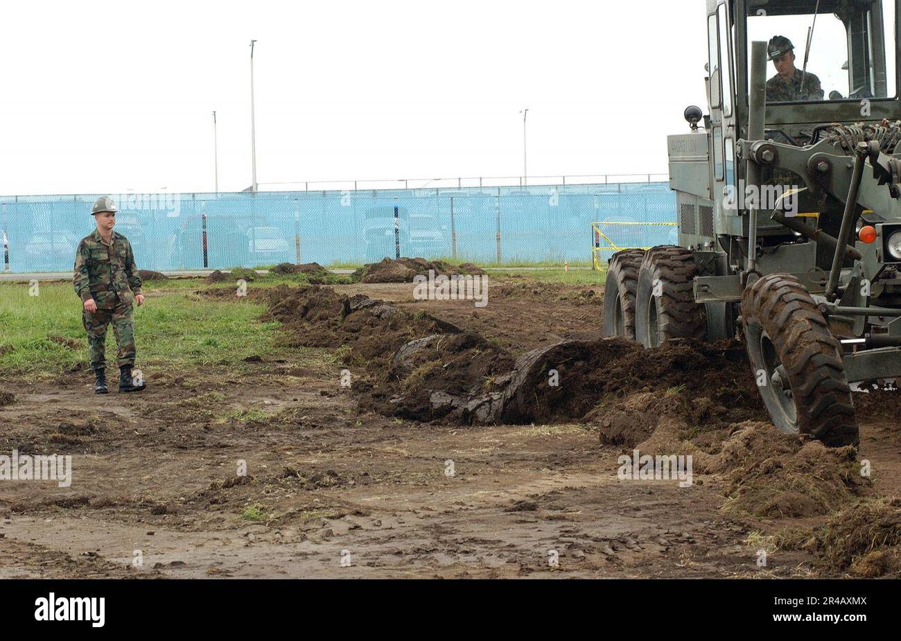 US Navy U.S. Navy Seabee, Builder 2nd Class prepares the landscape for ...