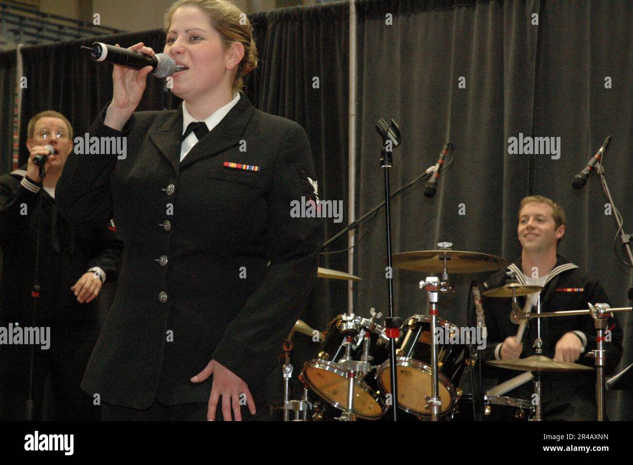 US Navy Musician 3rd Class sings lead vocals during a performance by ...