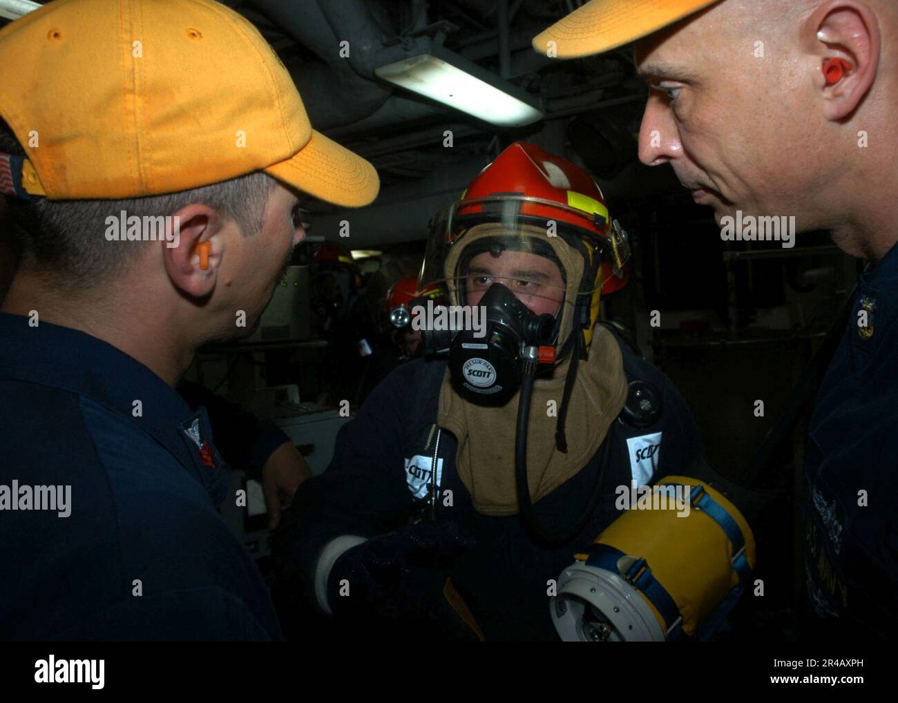 US Navy Damage Control Training Team members instruct a firefighting ...