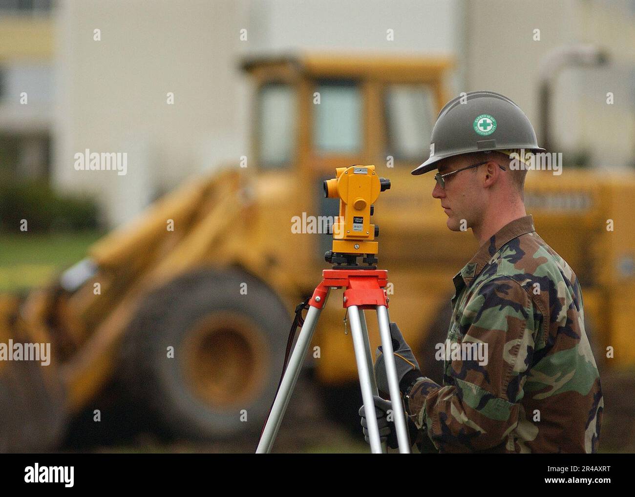 US Navy Engineering Aide 2nd Class surveys the perimeter of a ...