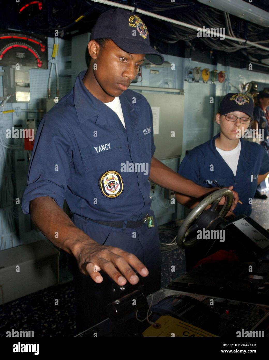US Navy Seaman stands watch on the bridge of the guided missile ...