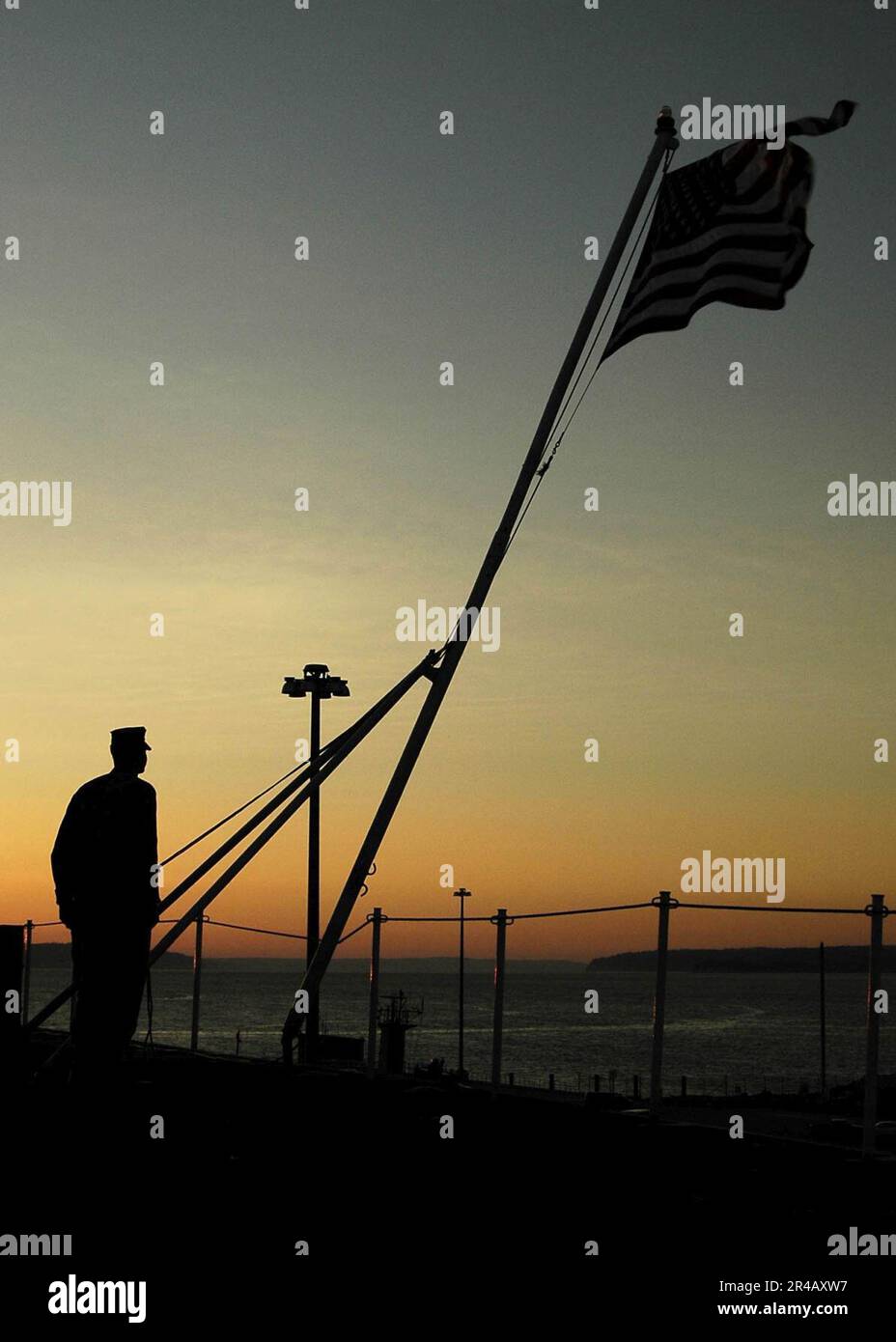 US Navy A Sailor assigned to Color Guard waits for the signal to lower ...