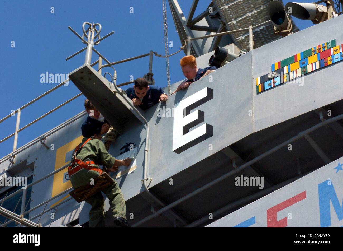 US Navy Quartermaster 2nd Class begins preparation for painting the U.S ...