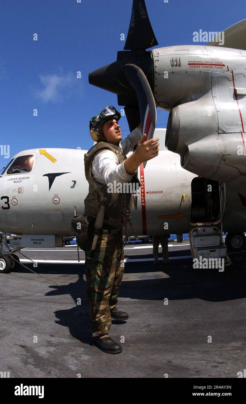 US Navy Aviation Machinist's Mate 3rd Class performs a pre-flight ...
