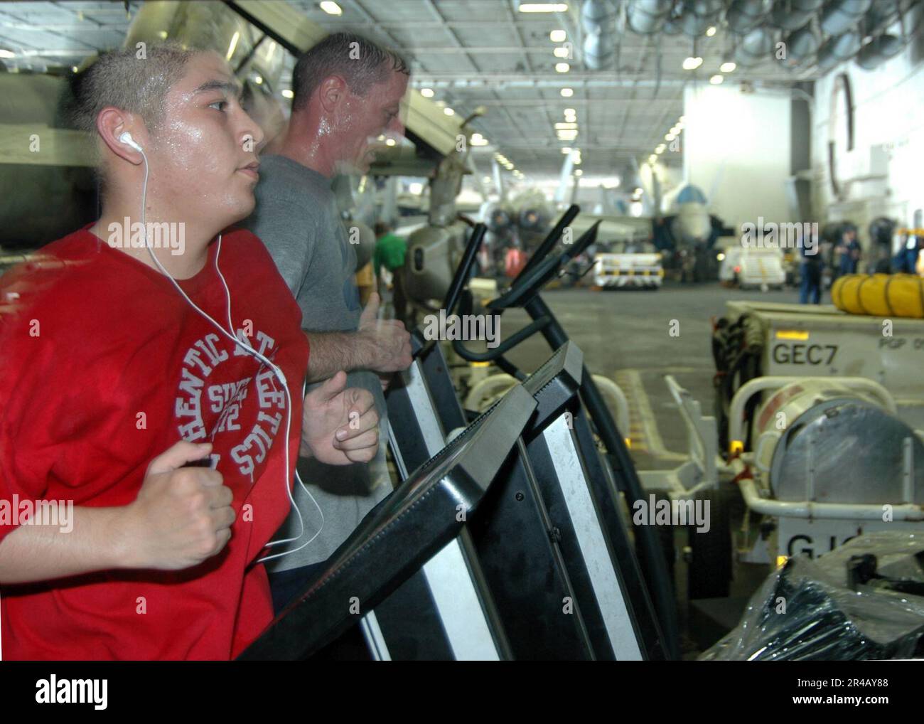 US Navy Sailors go for a run on the treadmills located in the hangar ...