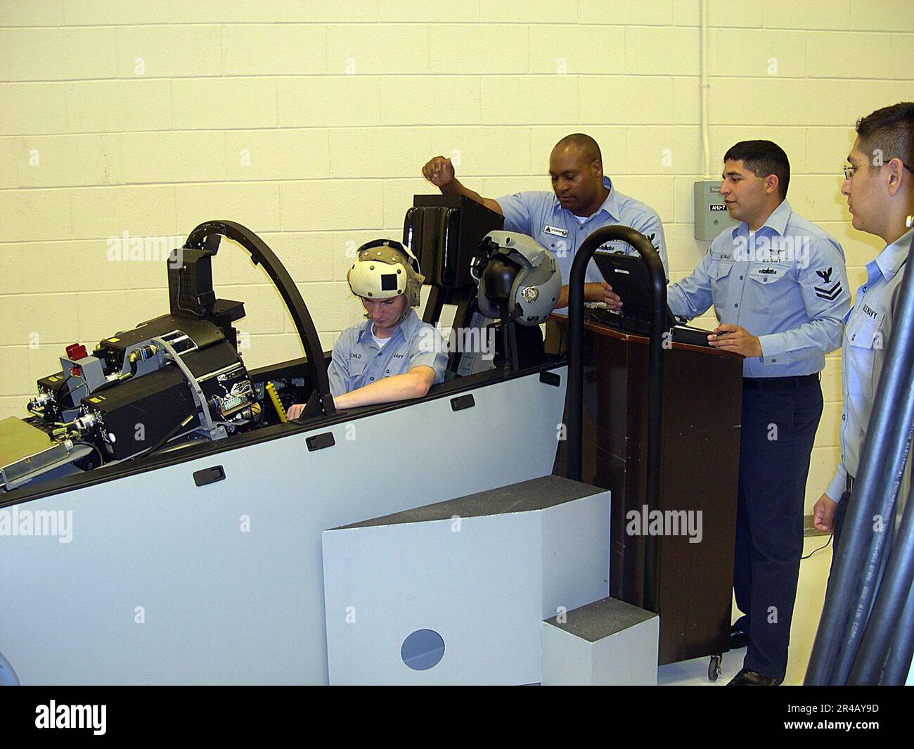 US Navy Aviation Electronics Technician 3rd Class sits in the cockpit ...