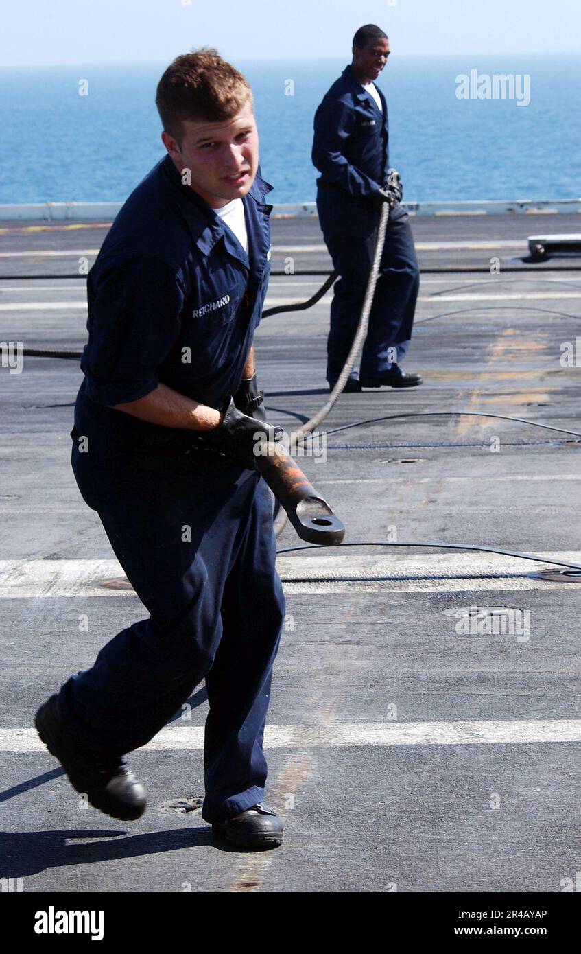 US Navy Arresting gear crew members, assigned to the V-2 Department ...