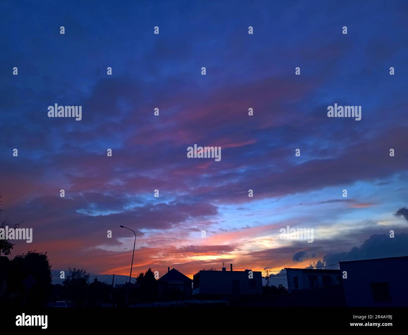 A beautiful and tranquil sunset with dark clouds in the sky, creating a ...