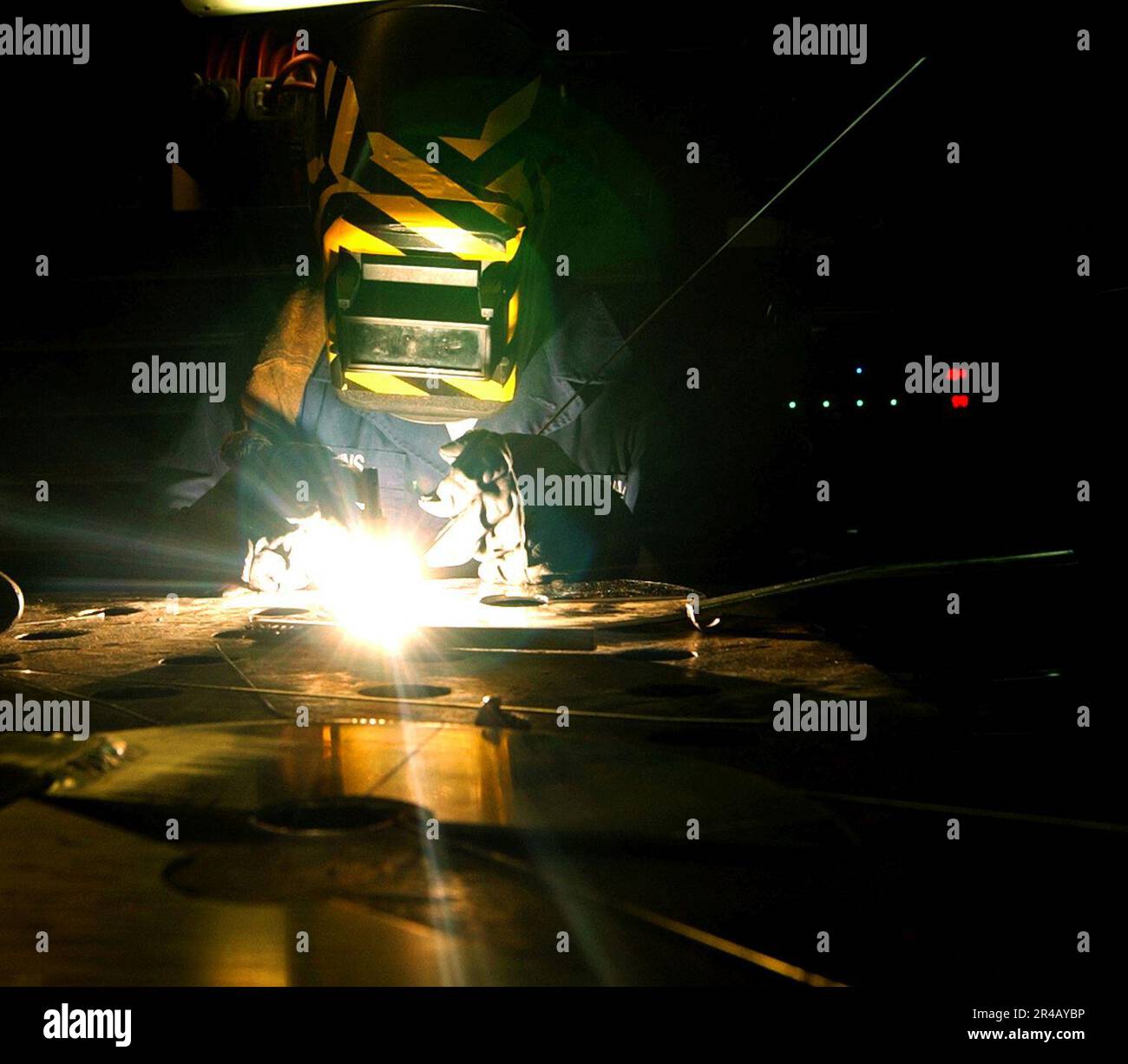 US Navy Hull Technician Fireman tig-welds clamshell locks for doors ...
