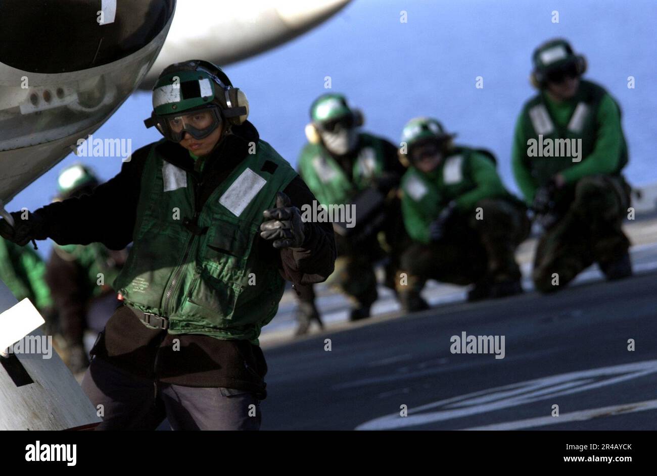 US Navy A top-side safety petty officer directs an E-2C Hawkeye ...