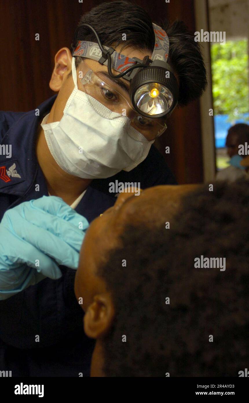 US Navy Dental Technician 1st Class performs a check up on a local ...
