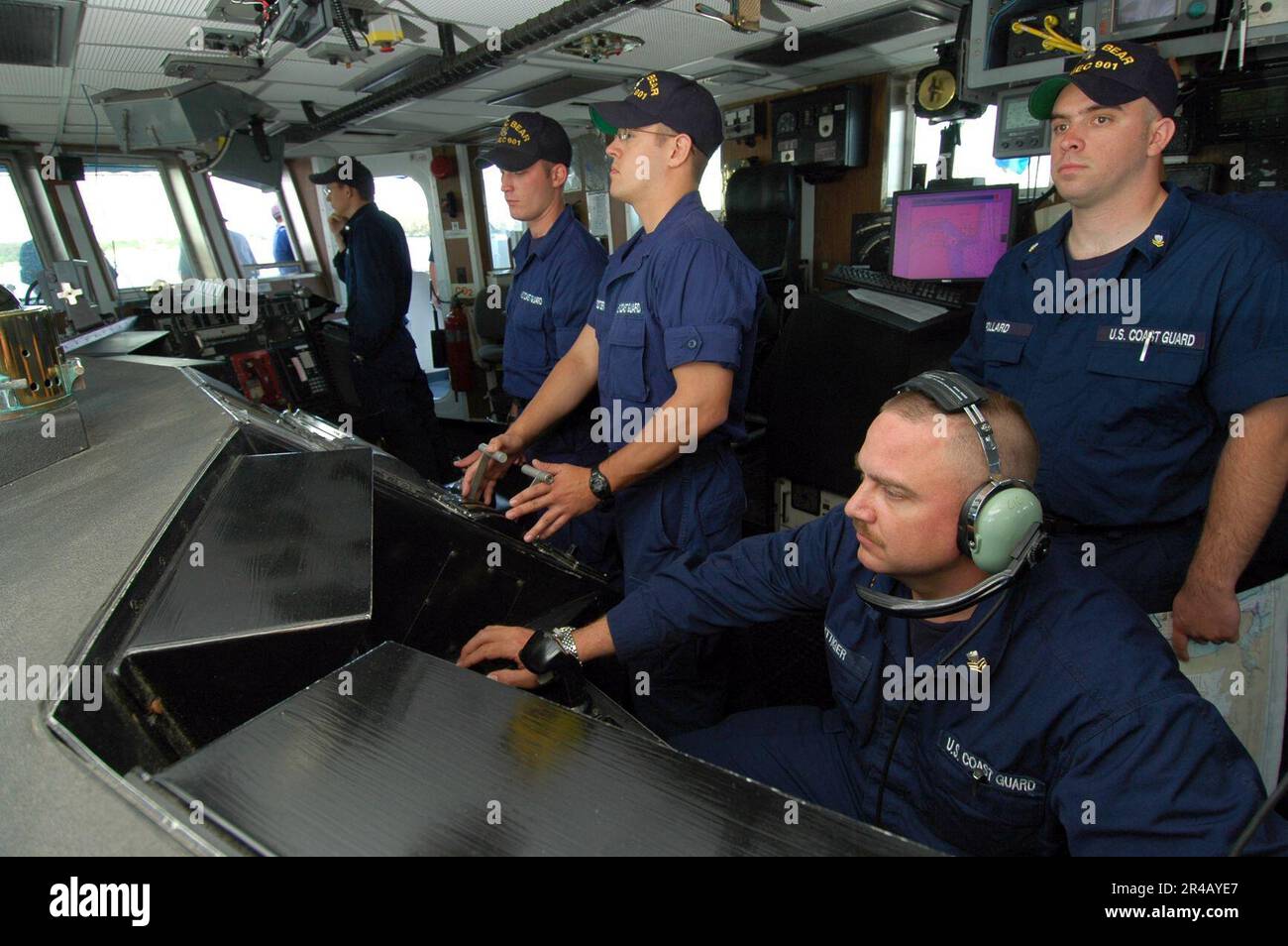 US Navy Crew members of the Coast Guard Cutter Bear (WMEC-901) stands ...