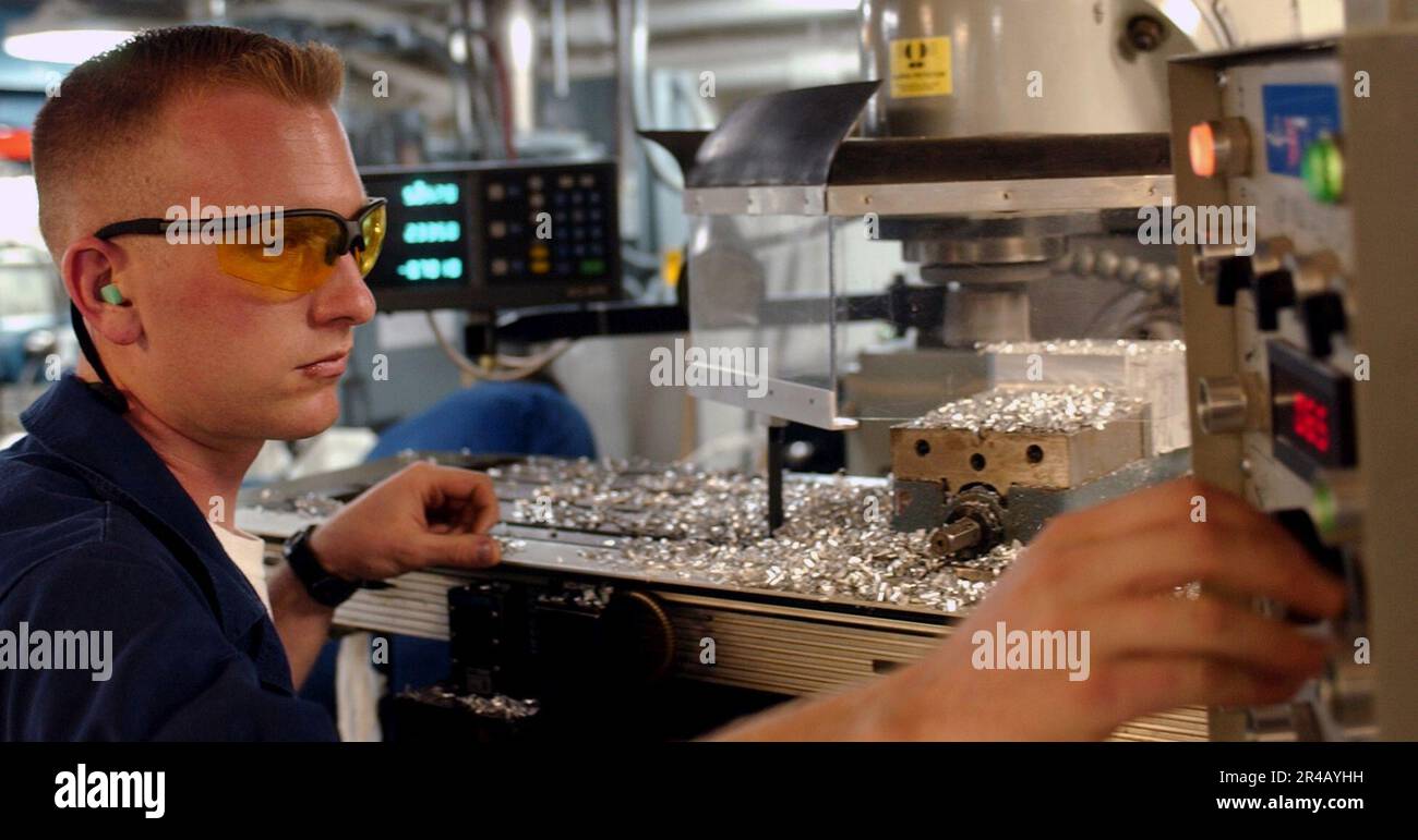 US Navy Machinery Repairman 3rd Class uses a universal milling machine ...