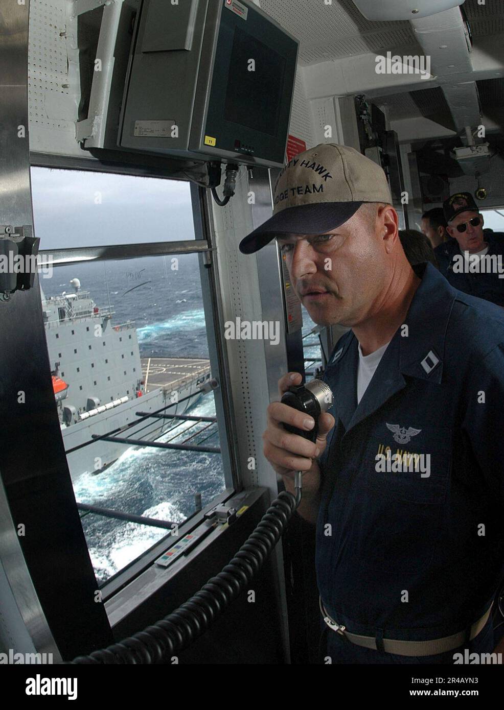 US Navy Lt. watches the lateral distance between the conventionally ...