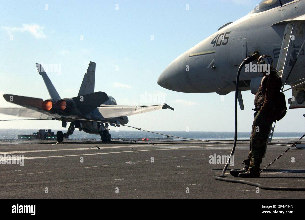 US Navy A Plane Captain observes a Marine Corps F-A-18D Hornet as it ...