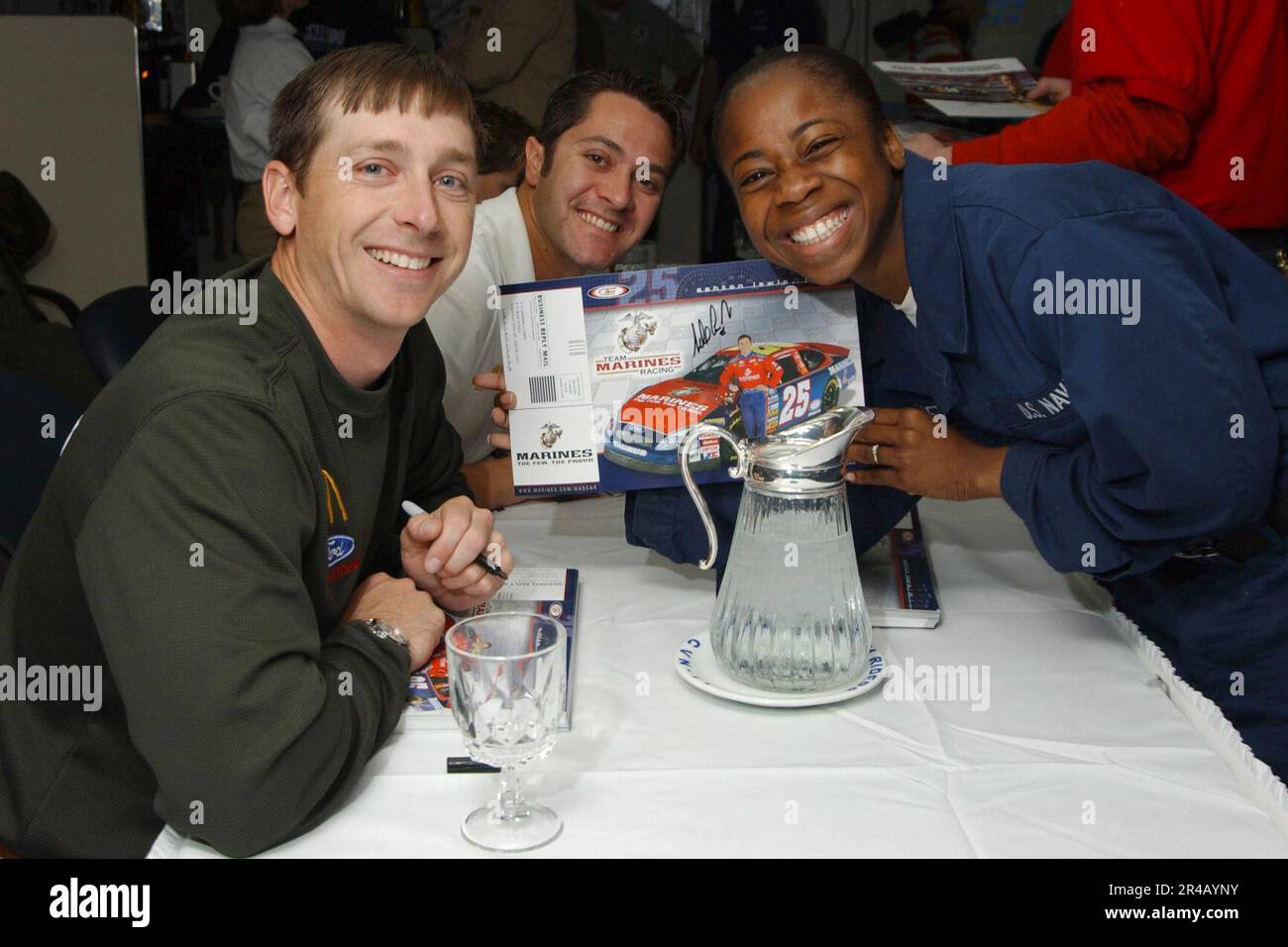 US Navy Aviation Machinist's Mate poses for a photograph with NASCAR ...