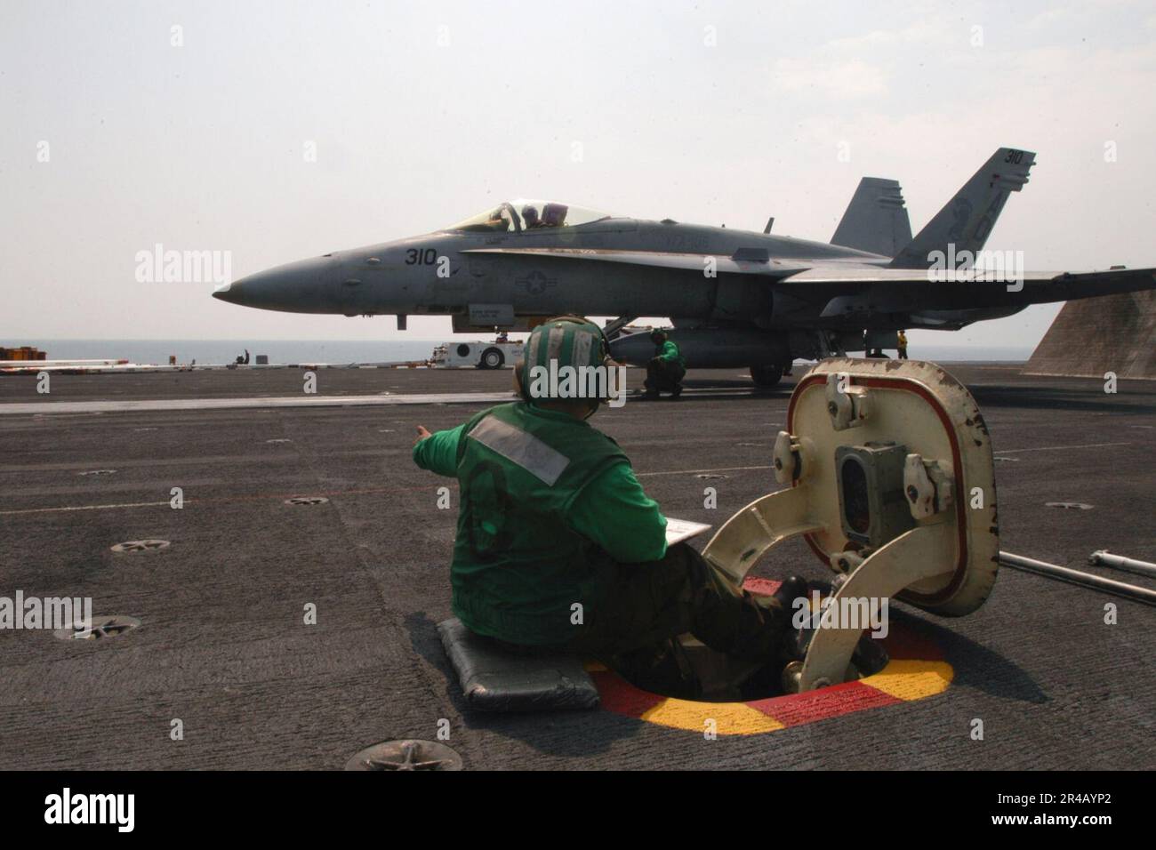 US Navy The center deck operator and topside petty officer wait for ...