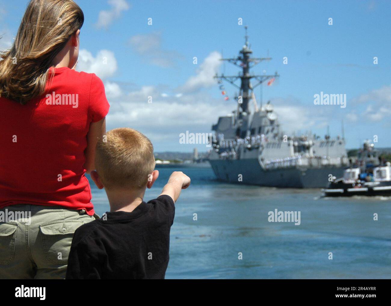 US Navy Family members of a Sailor stationed aboard the guided missile ...