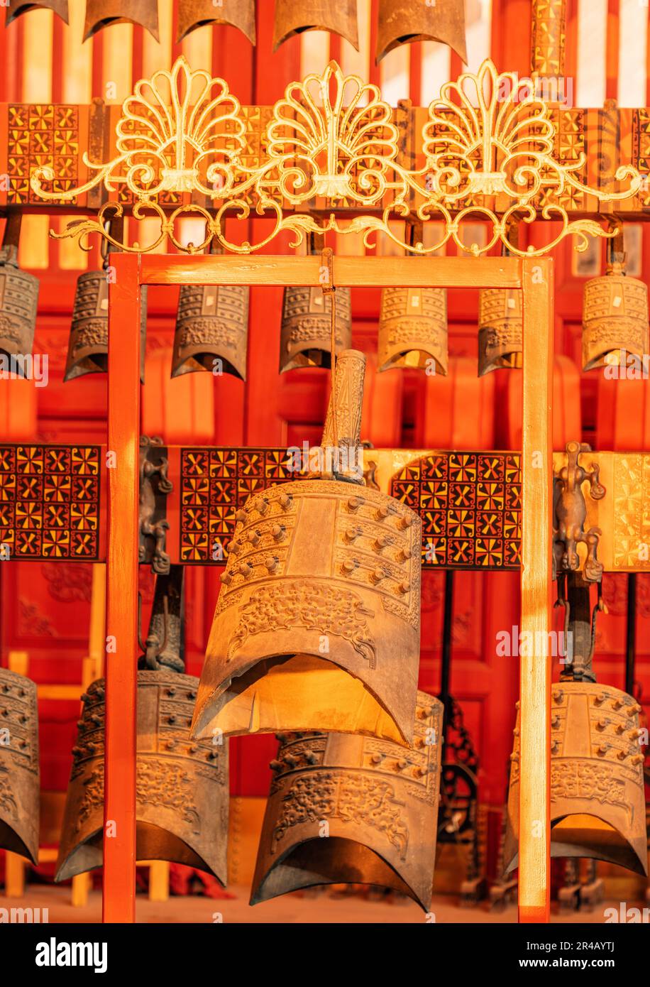 A diverse array of bells, of various sizes and tones, hang from a ...