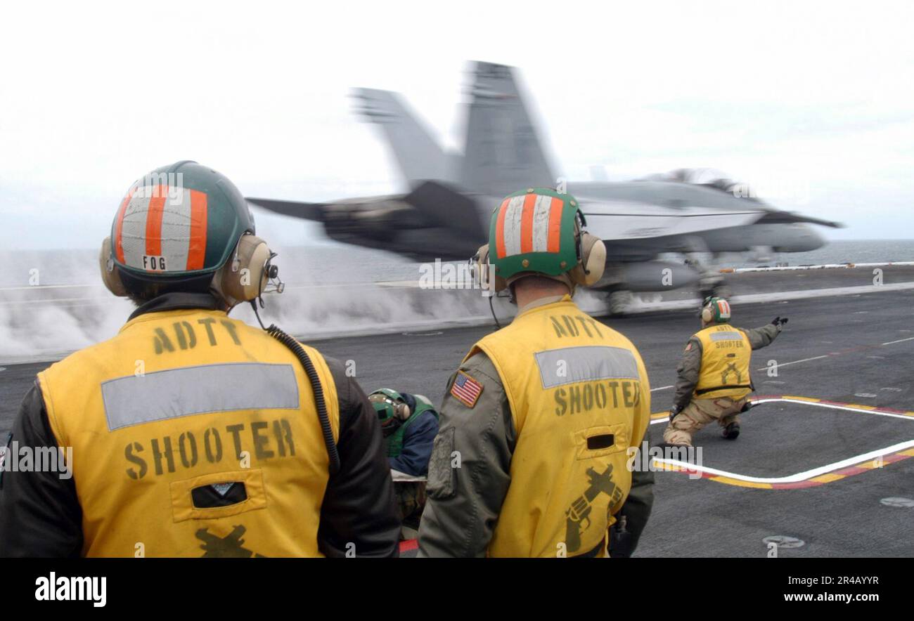 US Navy Lt. right, launches a F-A-18D Hornet of Strike Fighter Squadron ... US Navy Lt. right, launches a F-A-18D Hornet of Strike Fighter Squadron ...