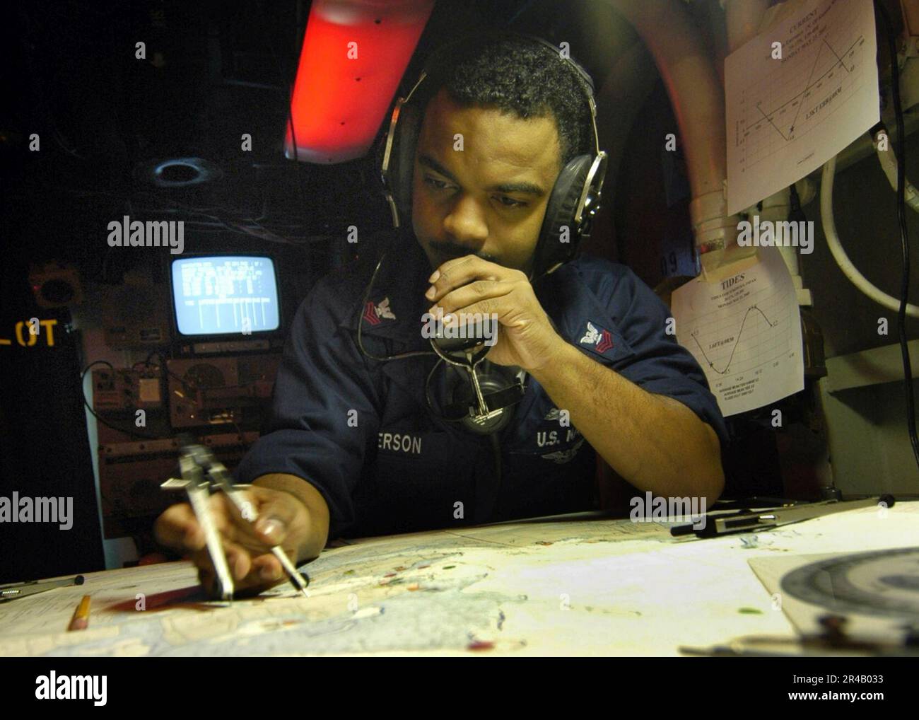 US Navy Operations Specialist 1st Class plots the transit course of the ...