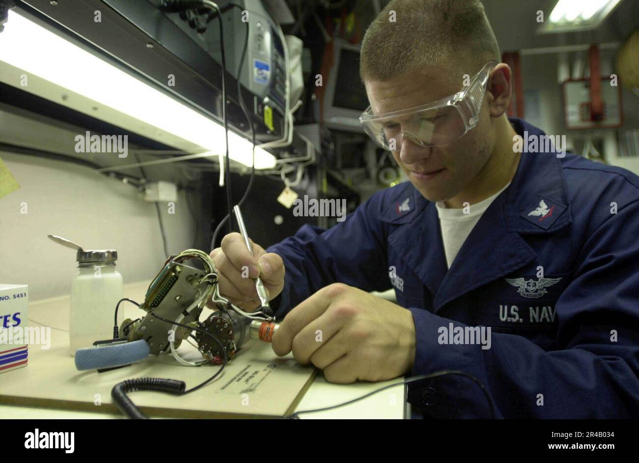 US Navy Aviation Electronics Technician 3rd Class repairs a pitch drive ...