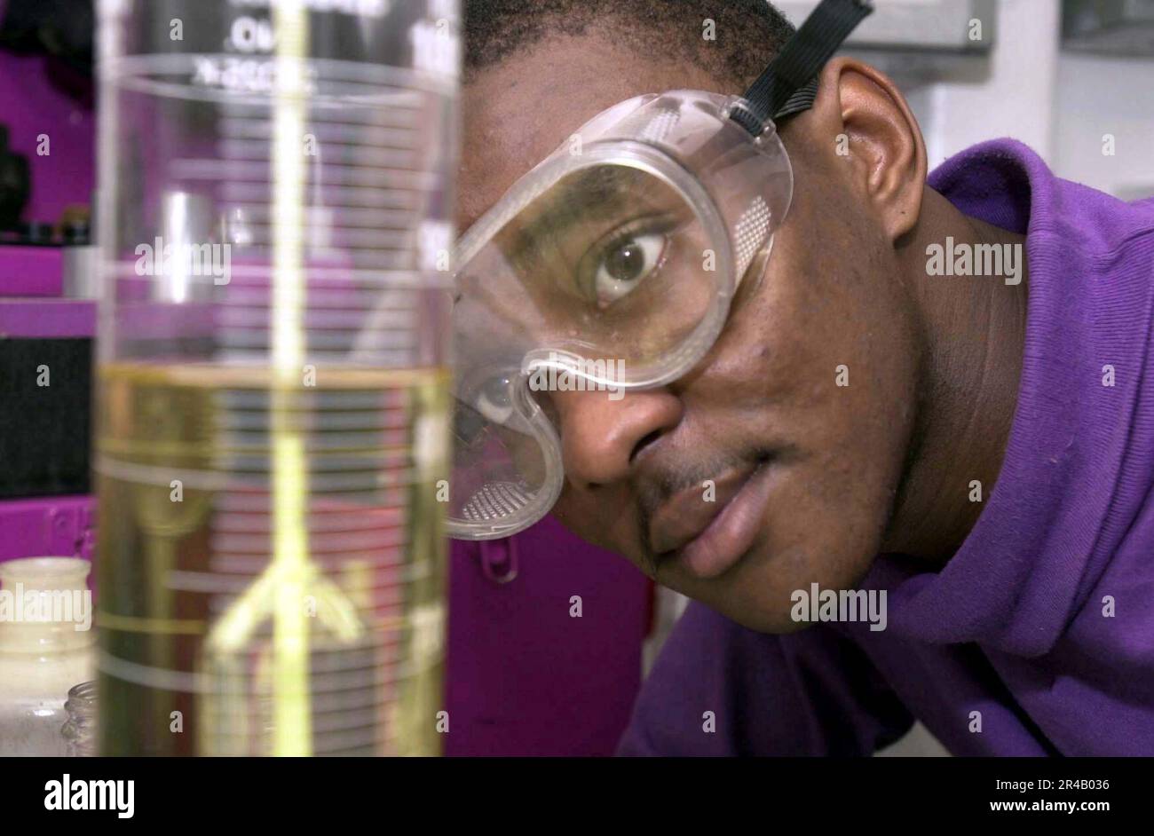 US Navy Aviation Boatswain's Mate Airman performs a specific gravity ...