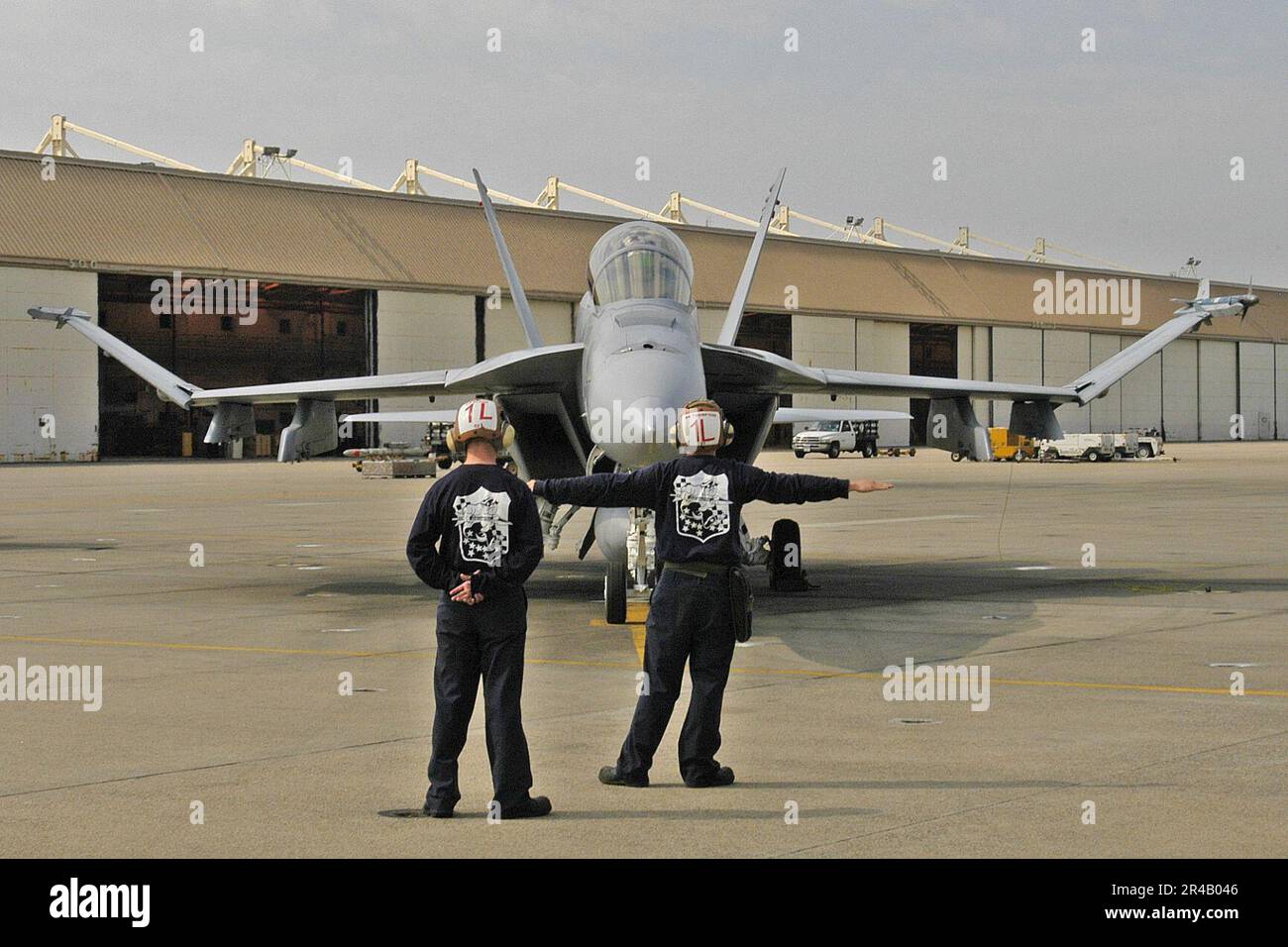 US Navy Flight-line personnel signal an F-A-18E Super Hornet from ...