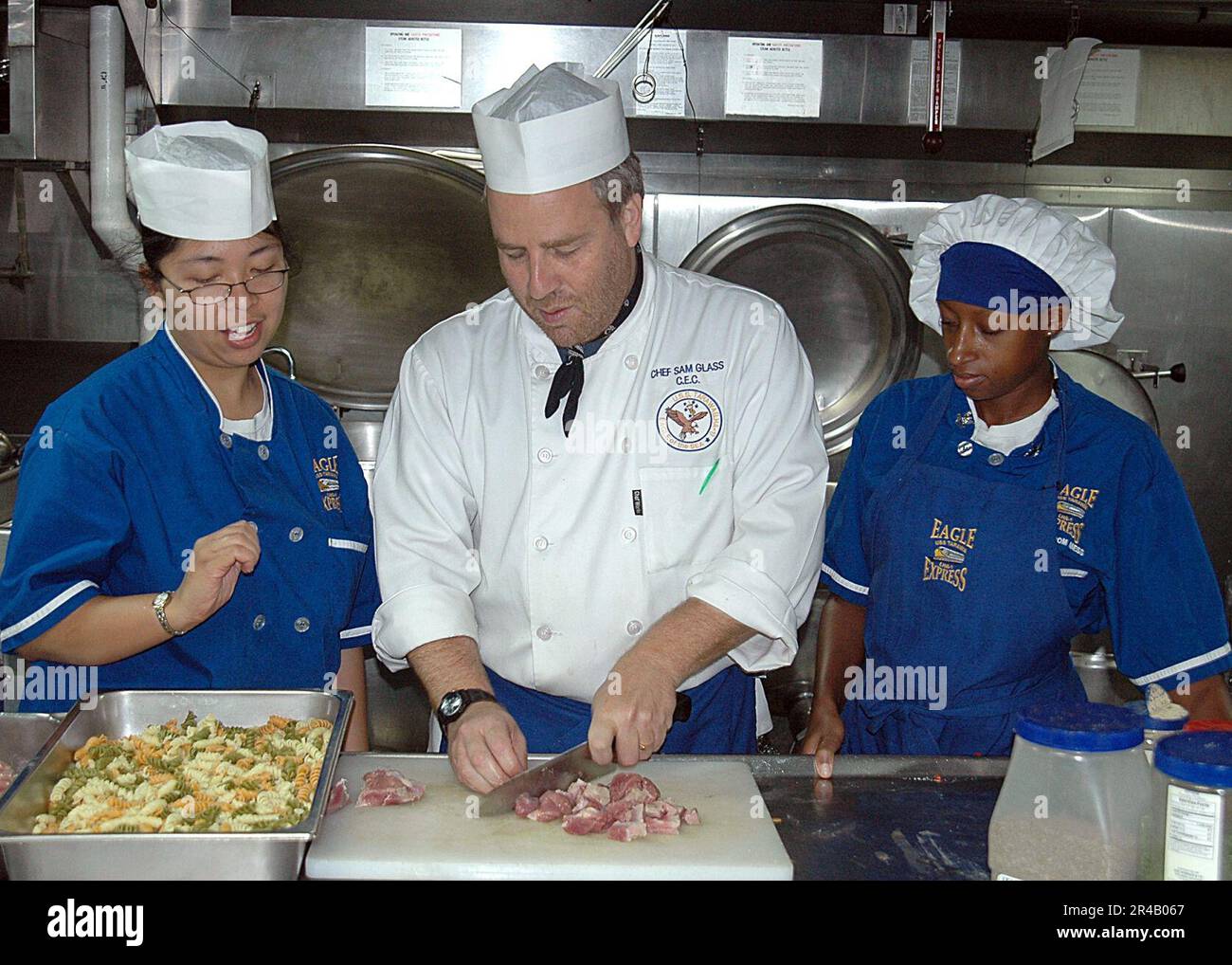 US Navy Culinary Specialist learn culinary tips from Chef aboard the ...