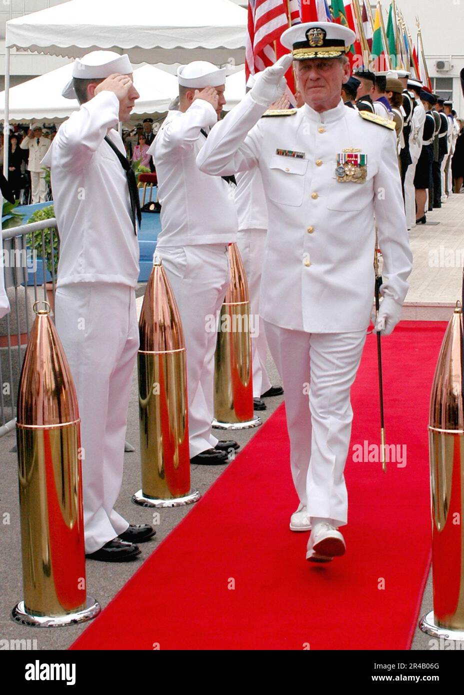 US Navy Adm. Harry Ulrich salutes his sideboys as he exits the change ...