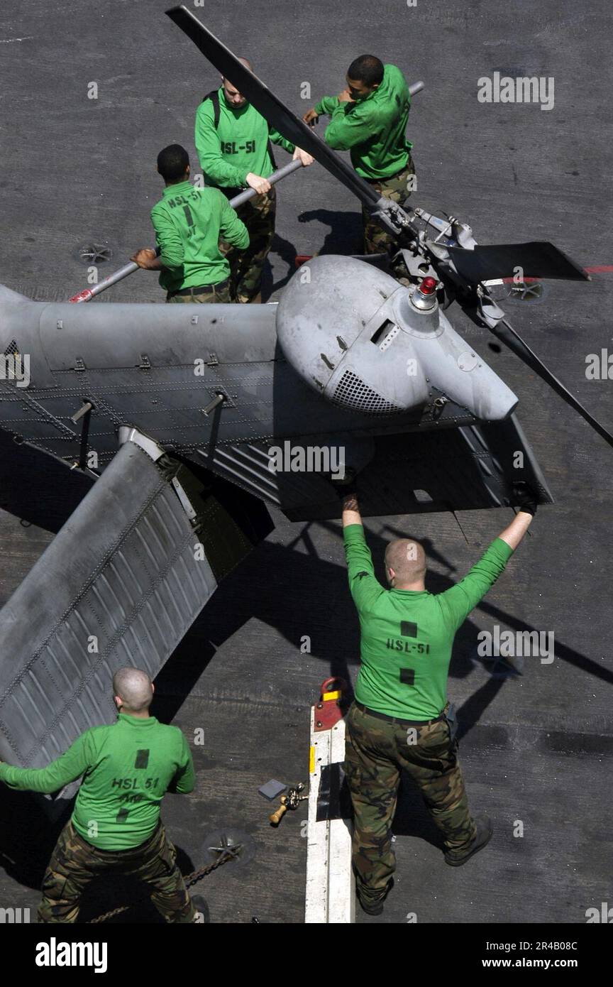 US Navy Sailors prepare to fold the tail rotor of an SH-60B Seahawk ...