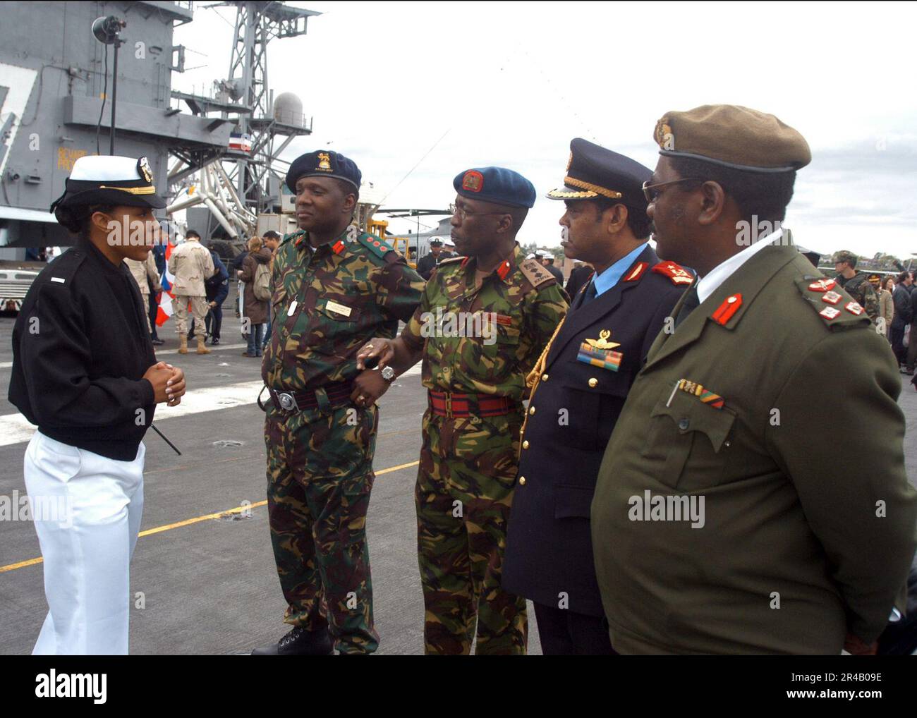 US Navy Lt.j.g. speaks with distinguished military guests during Fleet ...